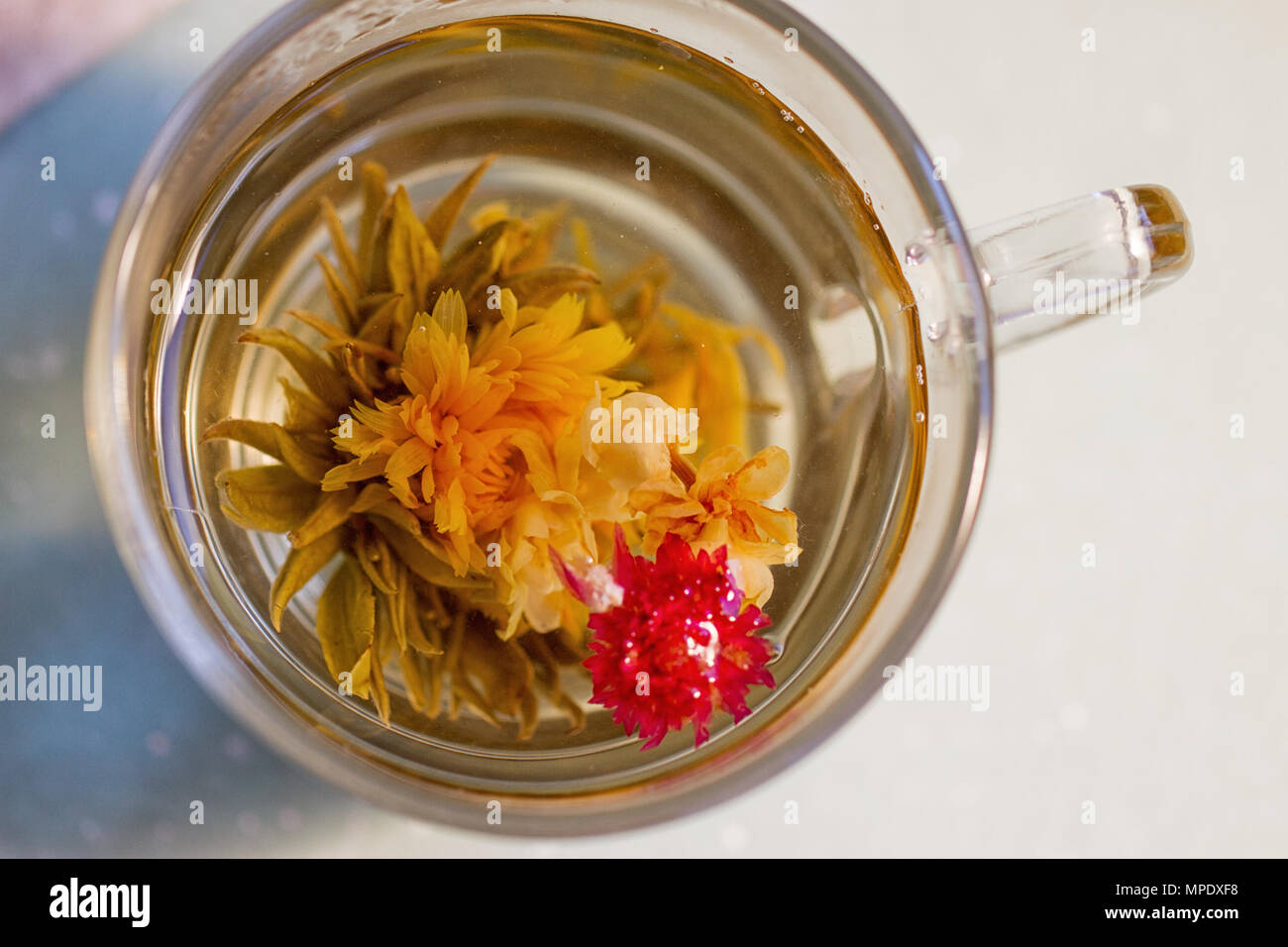 exotic green tea with flowers in glass cup Stock Photo - Alamy