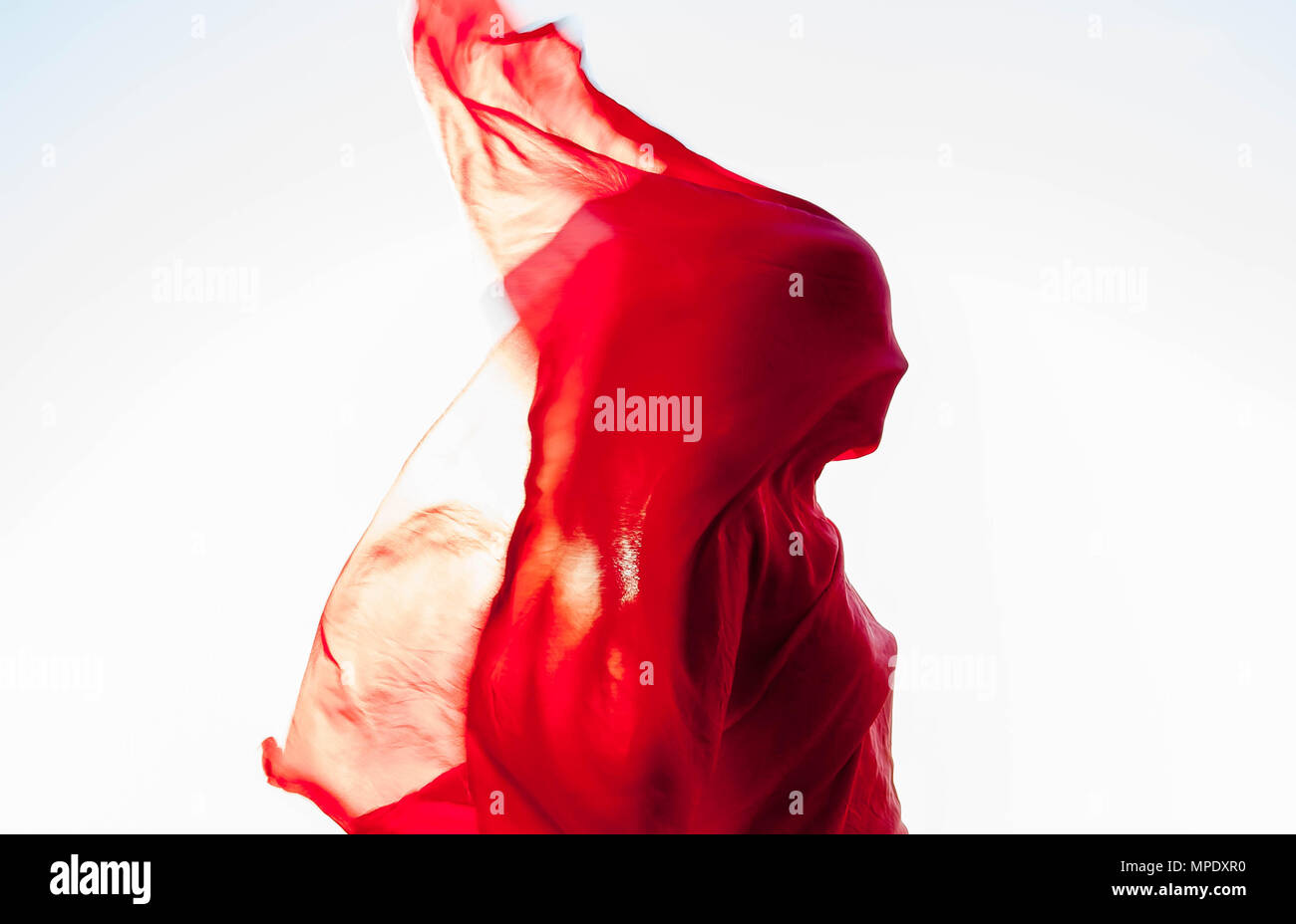 woman wrapped in a red scarf in the wind Stock Photo - Alamy