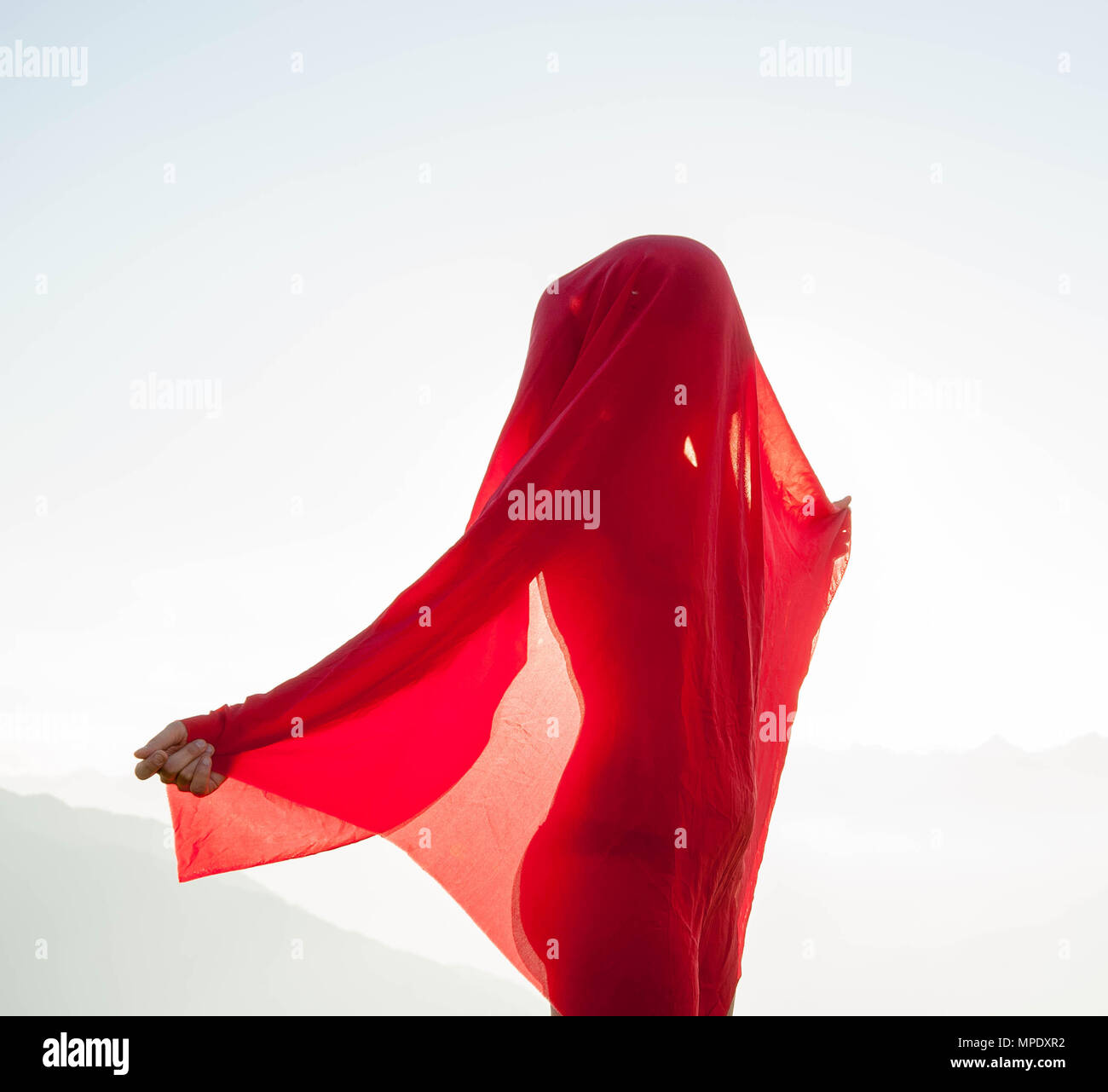 woman wrapped in a red scarf in the wind Stock Photo - Alamy