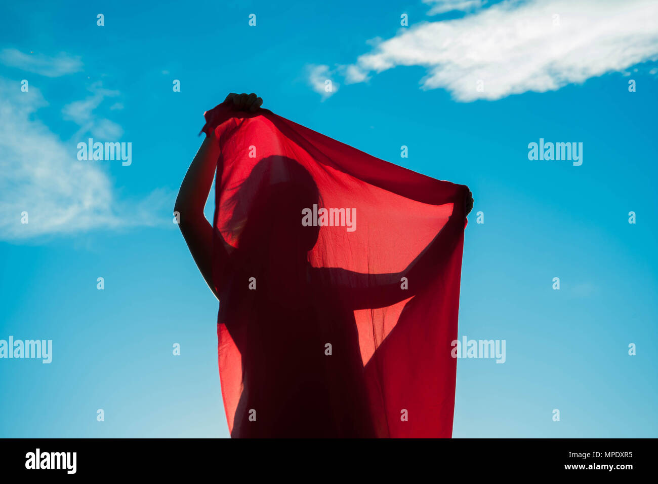 woman wrapped in a red scarf in the wind Stock Photo - Alamy