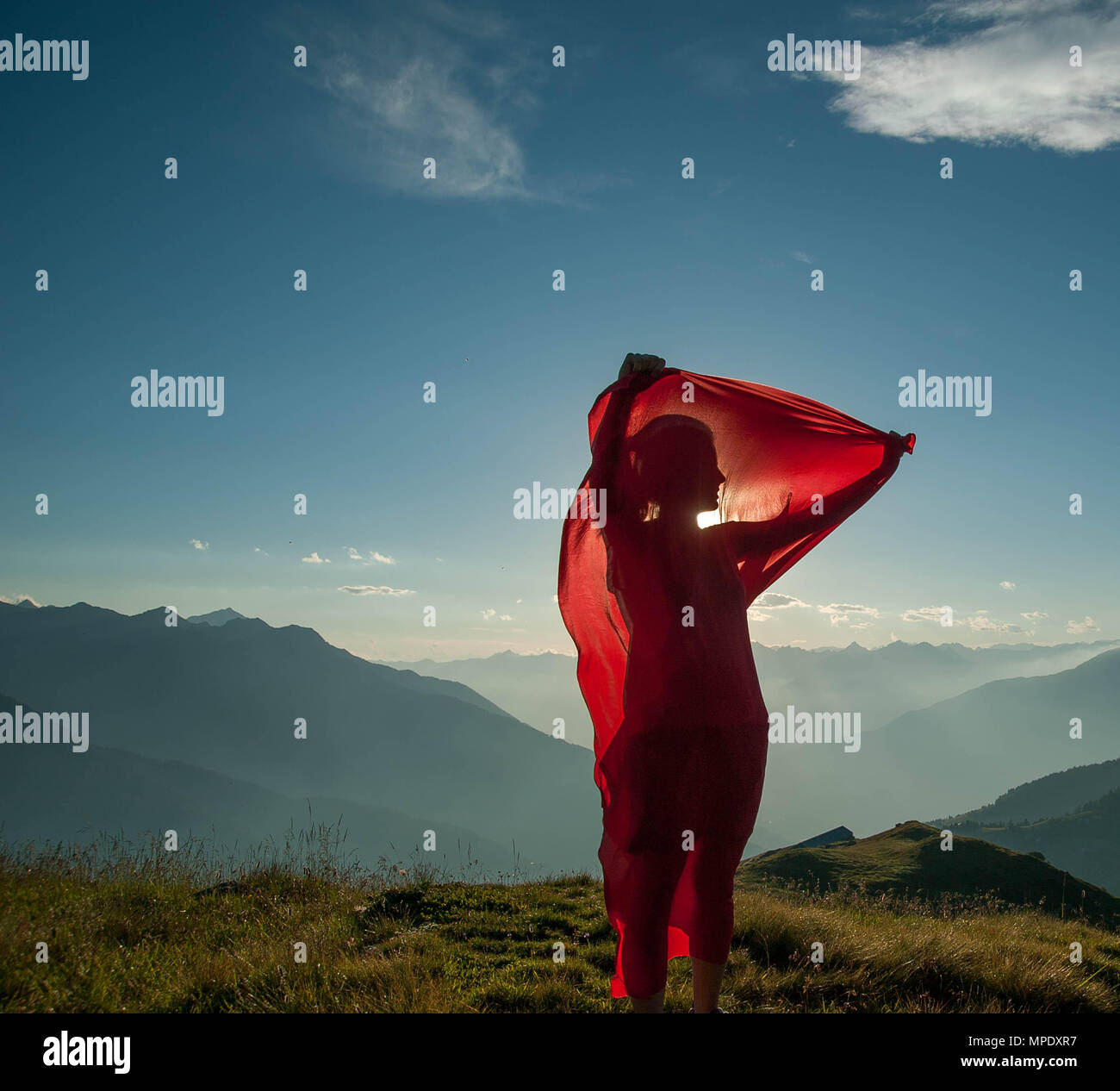 woman wrapped in a red scarf in the wind Stock Photo - Alamy