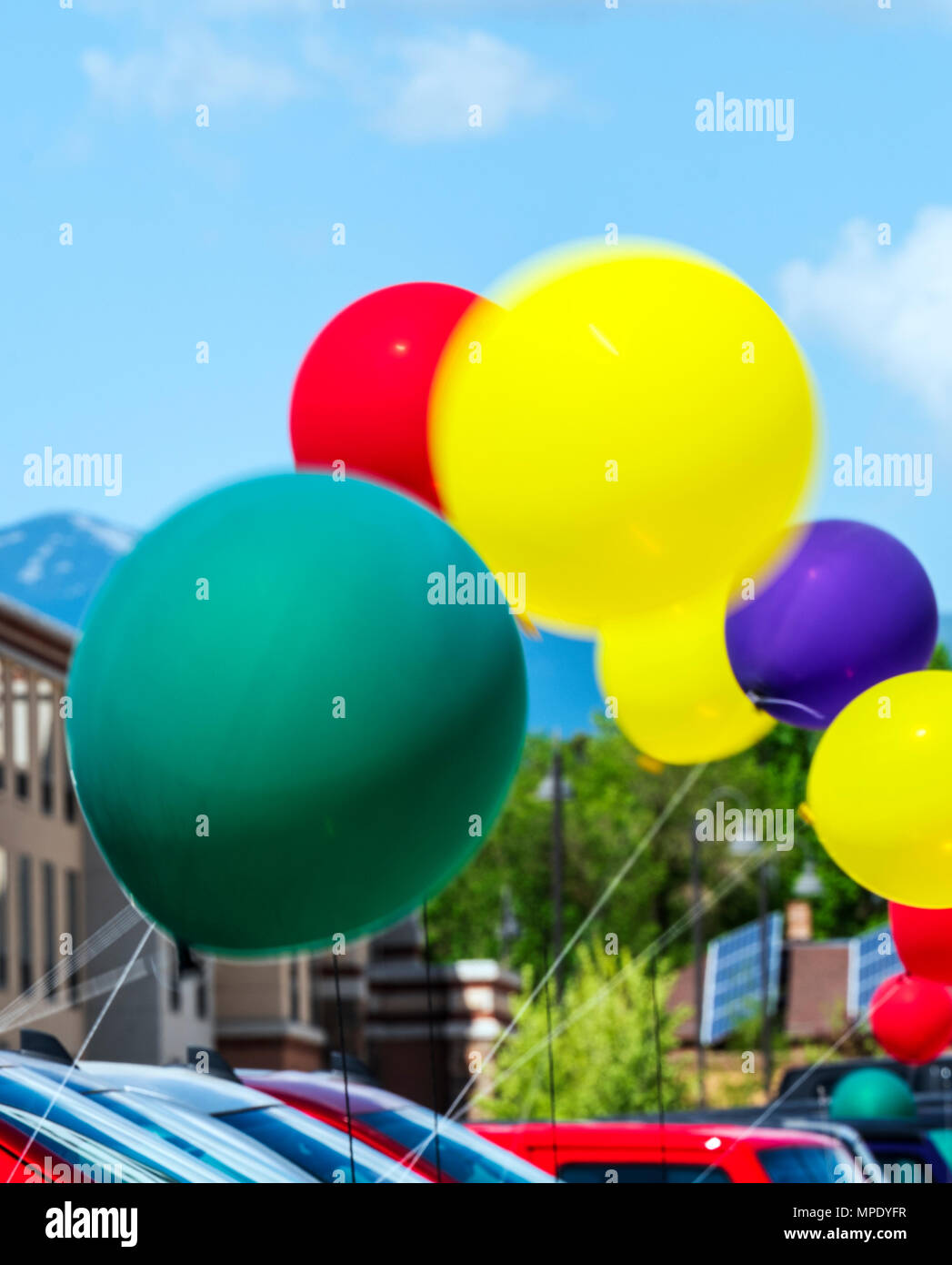 Pan; blur; motion view of colorful balloons; windy day; automobile ...