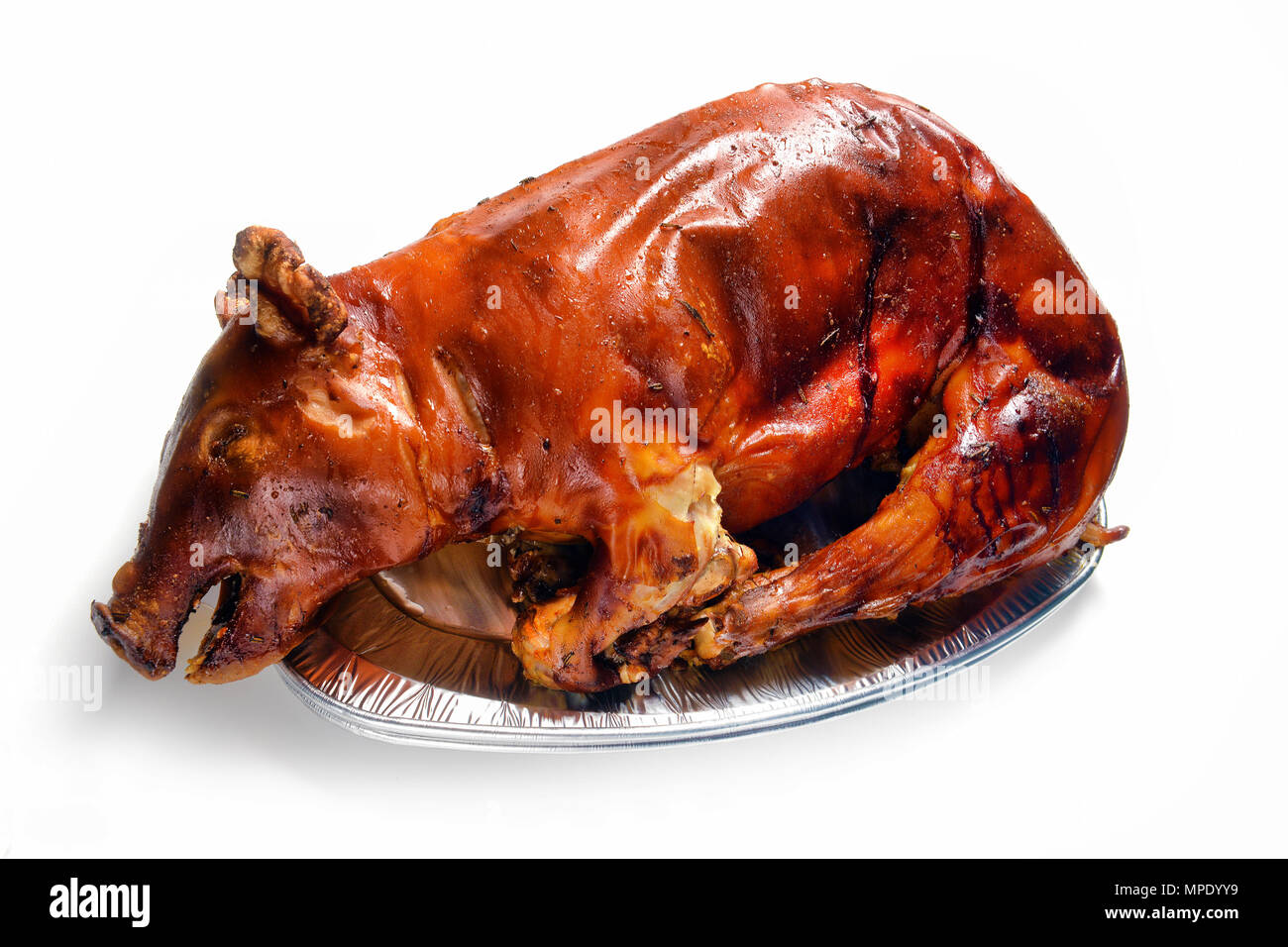 suckling pig roasted in the oven on a white background Stock Photo - Alamy