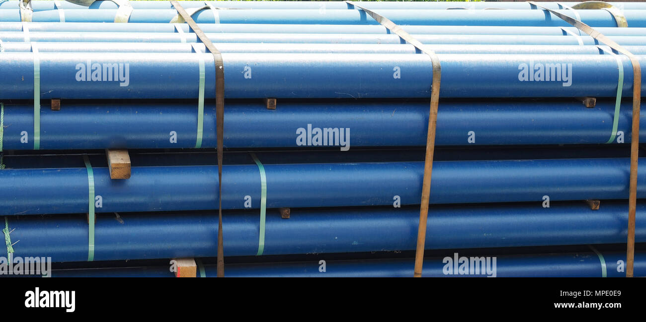 large blue pipes being transported on a truck Stock Photo - Alamy