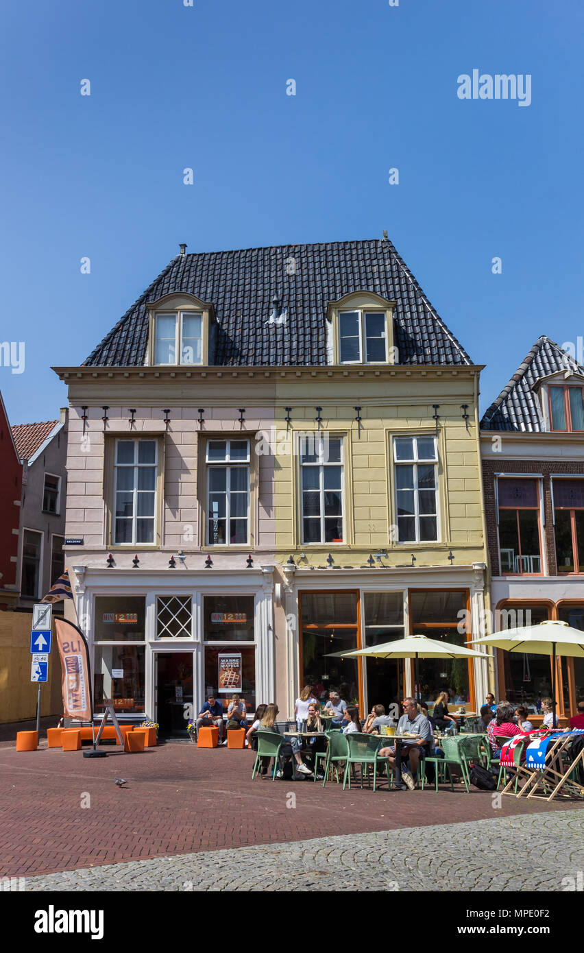 People sitting in the sun at an ice cream shop in Leeuwarden ...