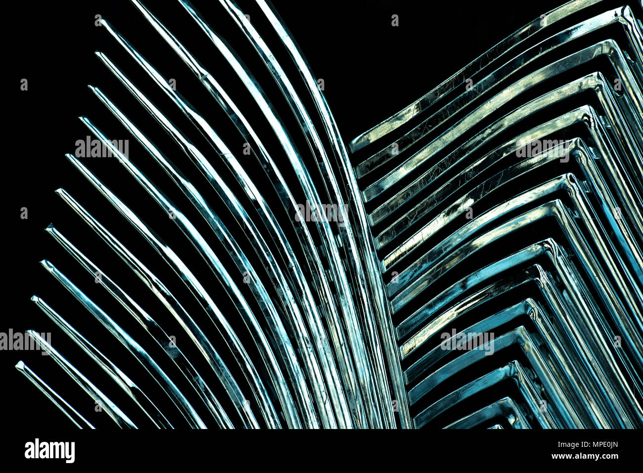 Sharp metal construction with a shiny surface on a black background ...