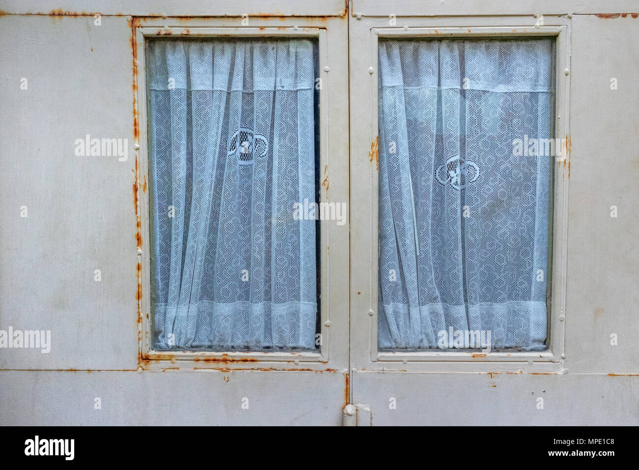 Rectangular windows with white vintage cloth curtains on a metal white ...