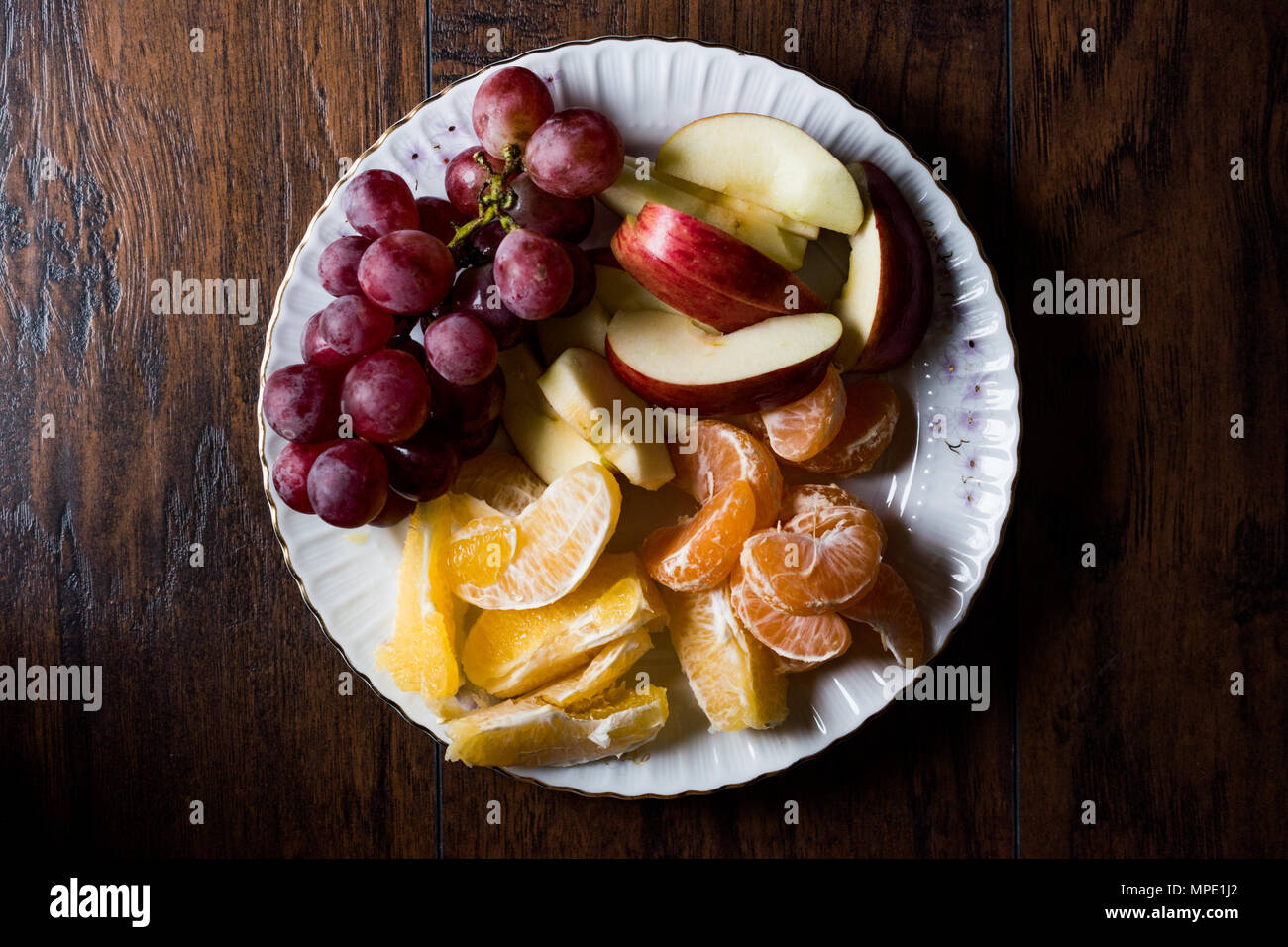 Fruit Plate with Purple Grape, Orange, Mandarin and Apple. Dark Moody ...