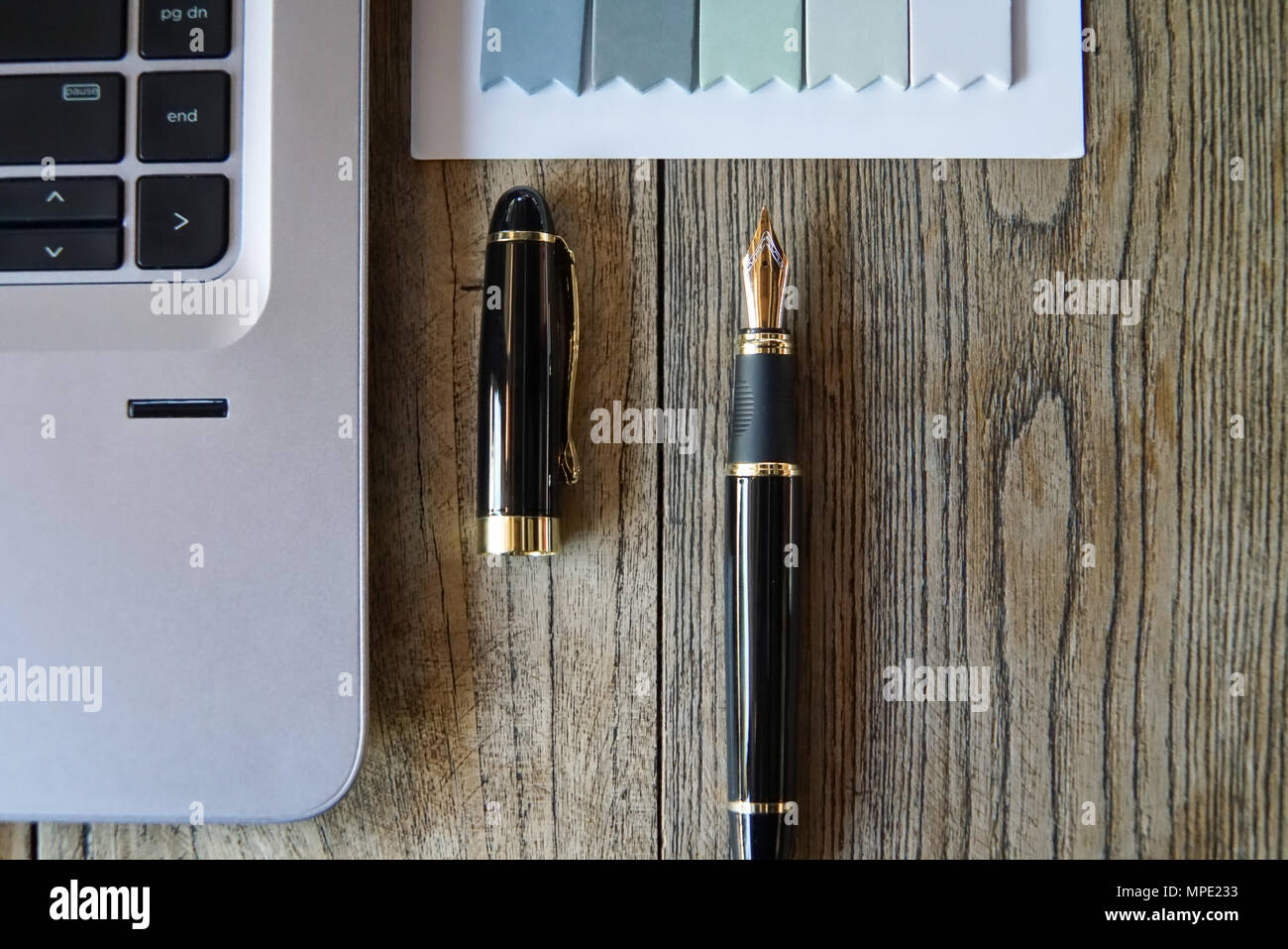computer laptop and luxury pen on working table flat lay composition ...