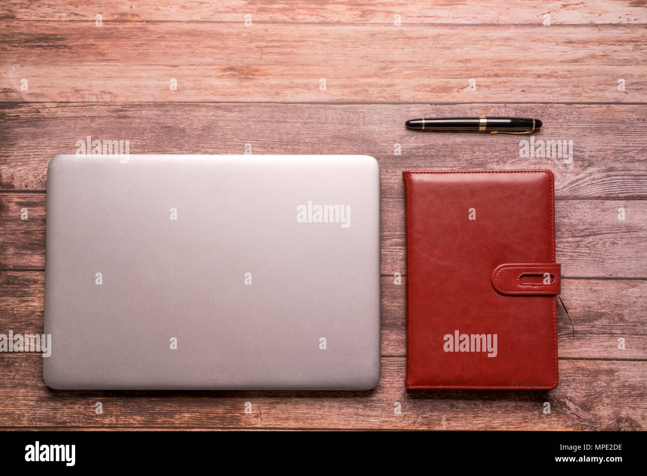 computer laptop and notebook on working table flat lay top view with ...