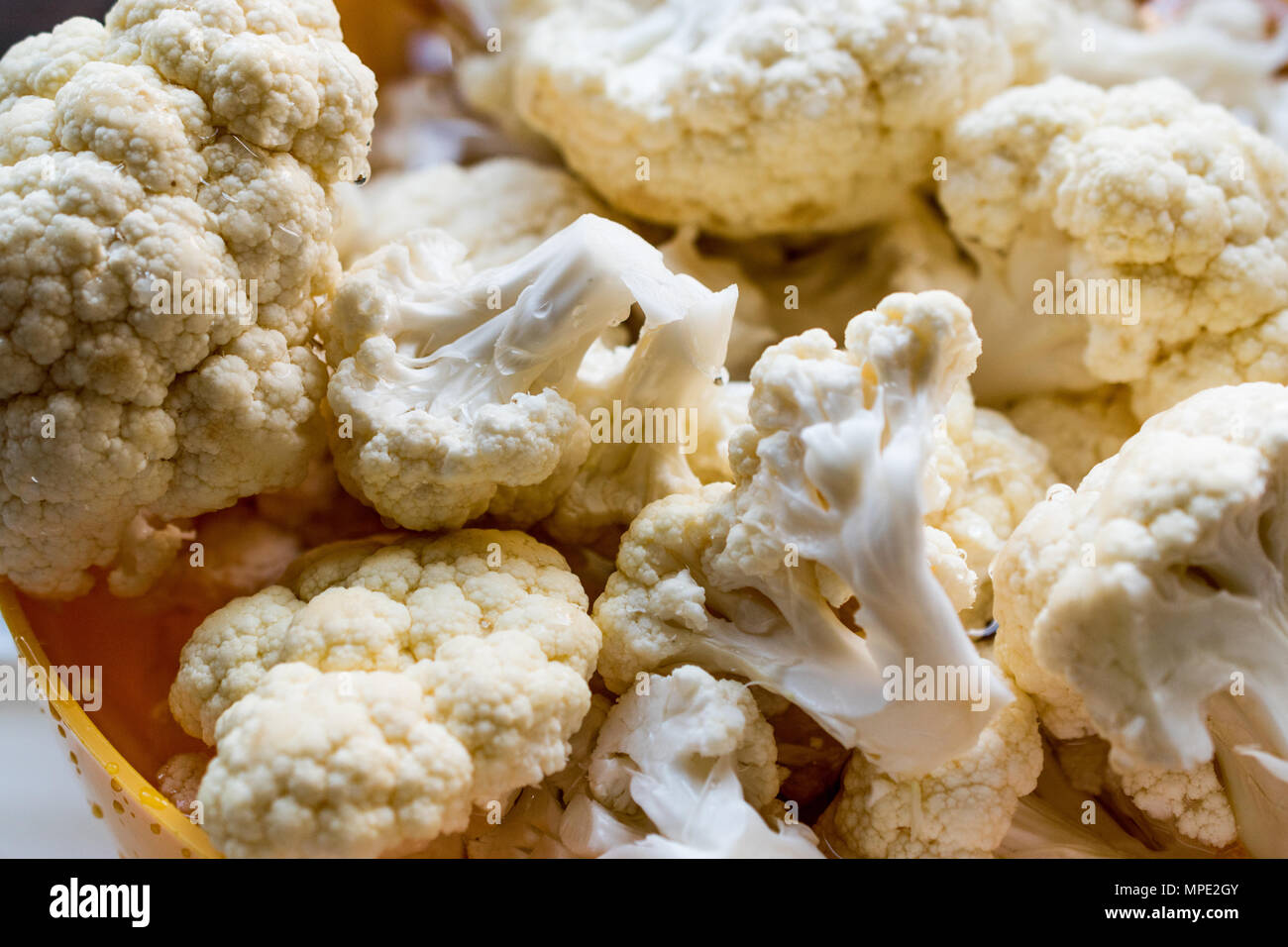 Fresh Heads Cleaned Cauliflower in yellow bowl. Organic Food Stock ...