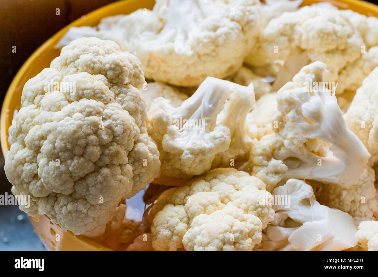 Fresh Heads Cleaned Cauliflower in yellow bowl. Organic Food Stock ...