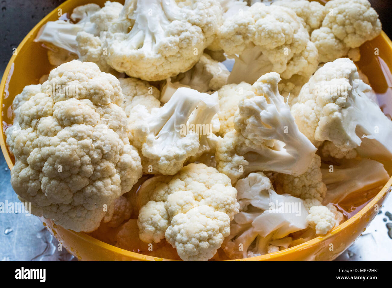Fresh Heads Cleaned Cauliflower in yellow bowl. Organic Food Stock ...