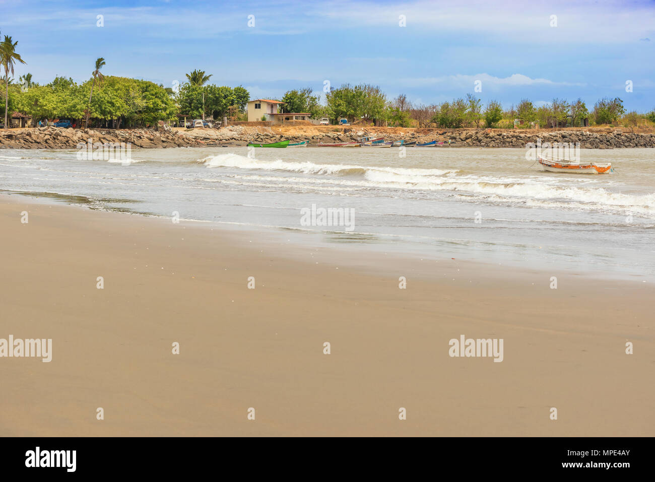 Small fisherman boats at the bay and the houses in El Rompio village ...