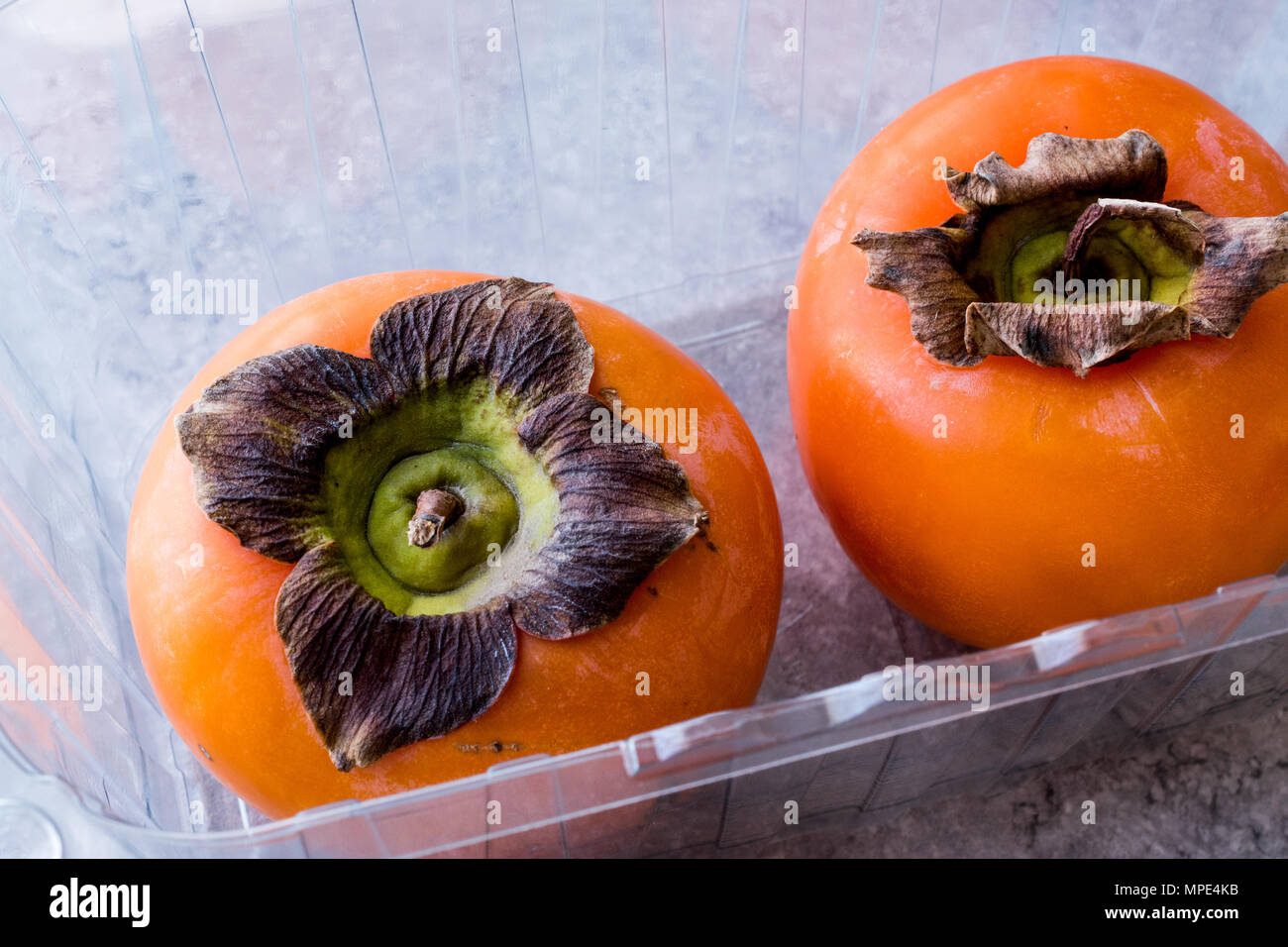 Fresh Persimmon Fruits in Plastic Box. Organic Food Stock Photo - Alamy