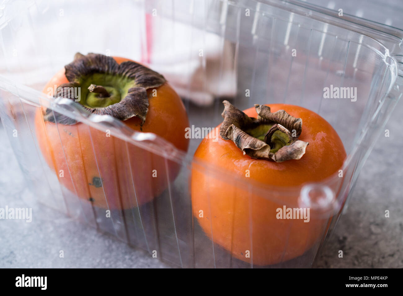 Fresh Persimmon Fruits in Plastic Box. Organic Food Stock Photo - Alamy