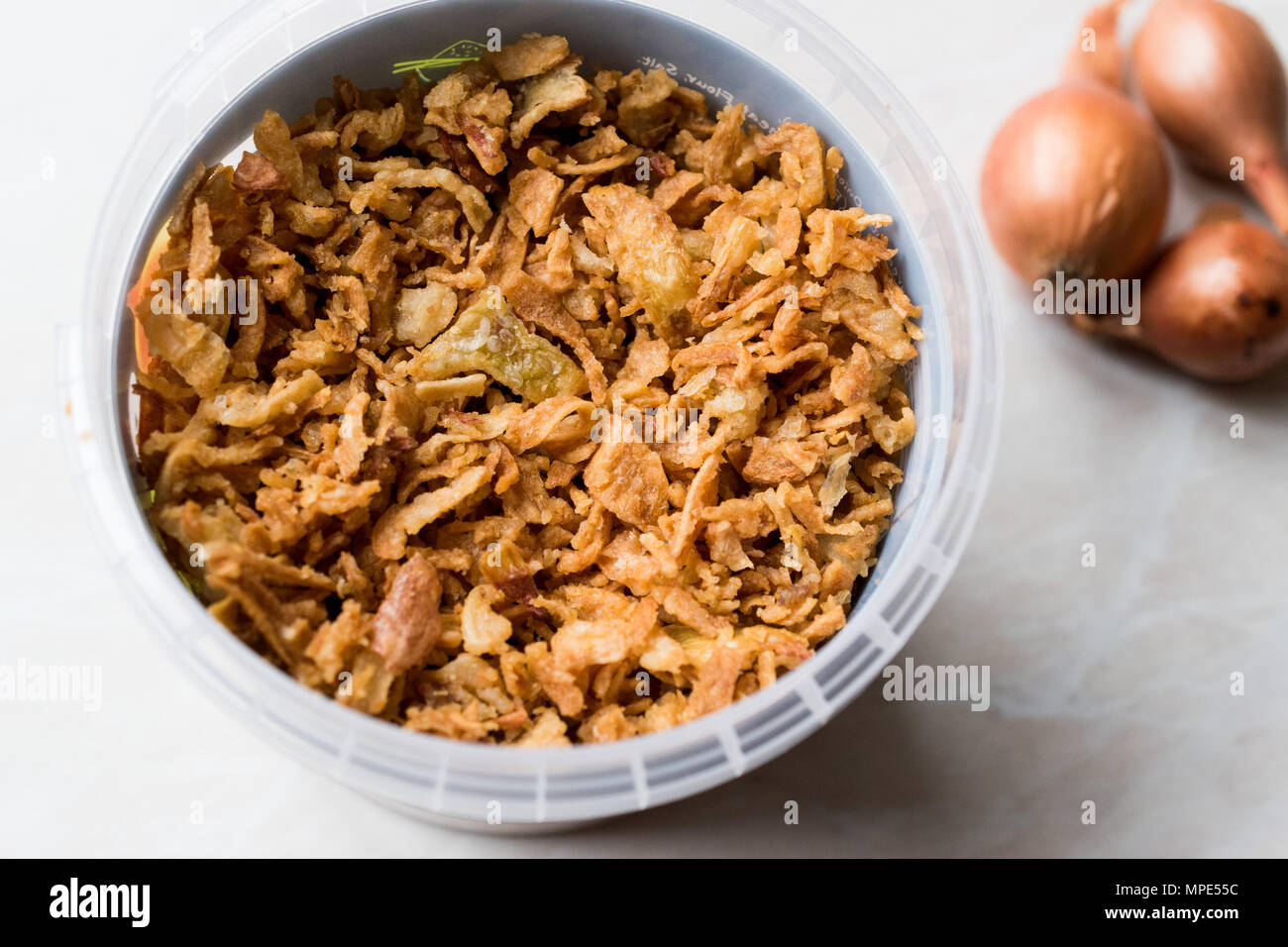 Fried Crispy Onion Flakes in Plastic Package Bowl. Organic Food Stock ...