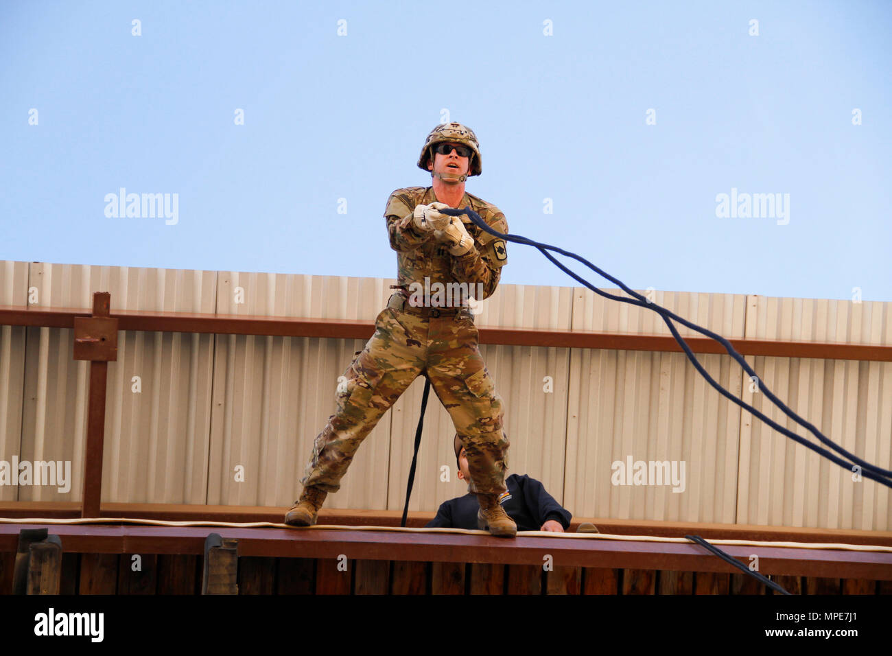 U.S. Army Capt. Brad Barron leans off the tower to rappel Aussie style ...
