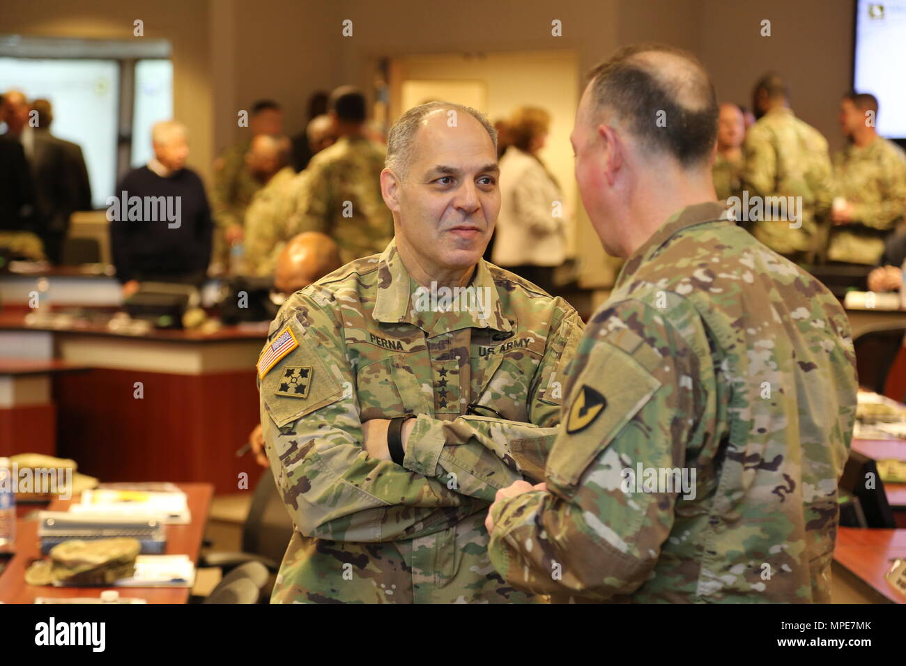 Army Materiel Command's Gen. Gus Perna speaks with an attendee at a ...
