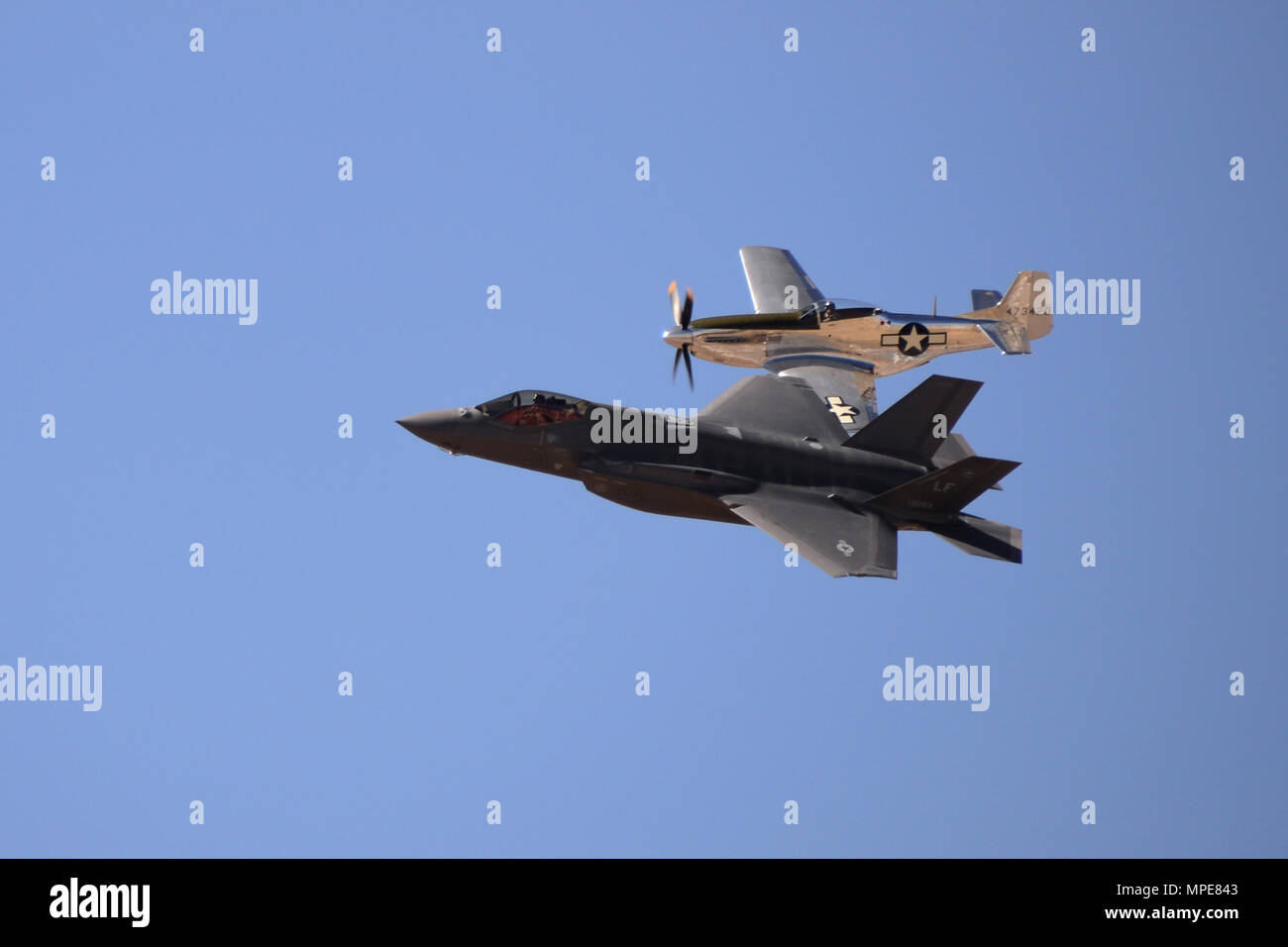 A U.S. Air Force F-35 Lightning II and a P-51 Mustang fly in formation ...