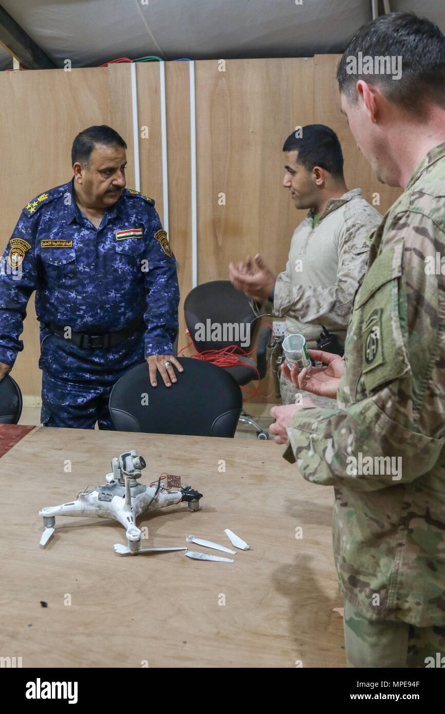 An Iraqi federal police operations officer (left) discusses ISIL ...