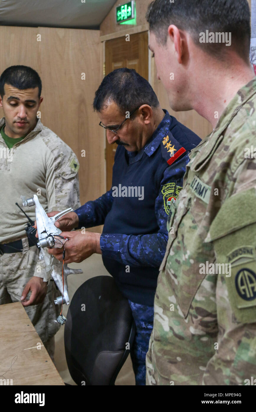 An Iraqi federal police operations officer (center), U.S. Army Capt ...
