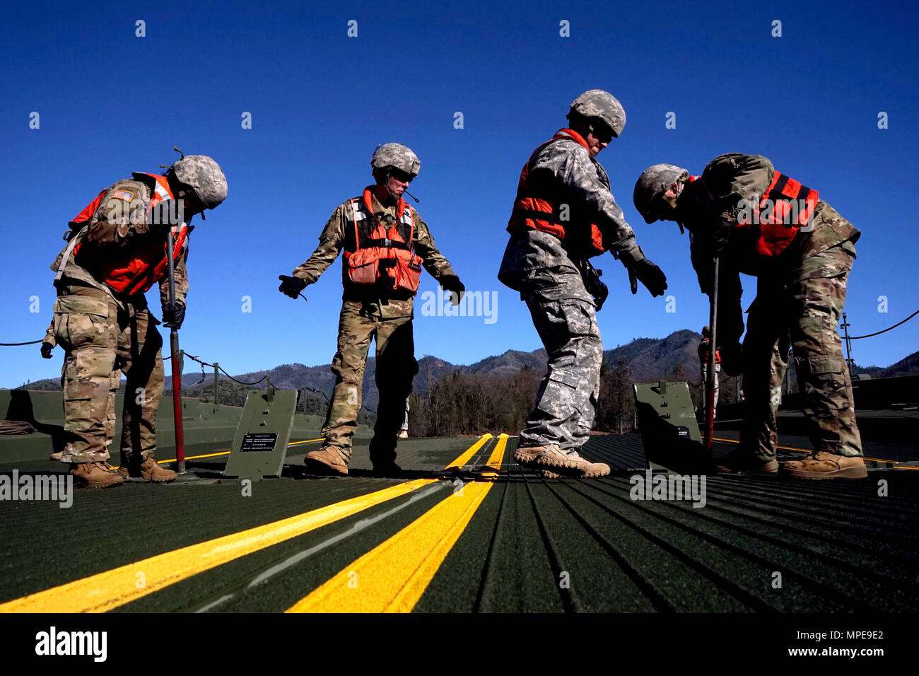 Guardsmen from the 132nd Multi-Role Bridge Company work to secure a ...