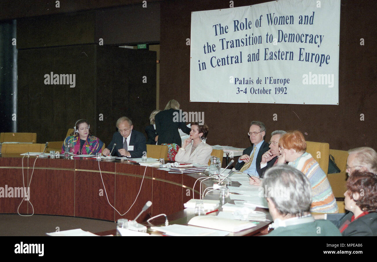 A GROUP OF MEN AND WOMEN SITTING ON THE PANEL WHICH THEY ARE HAVING A ...