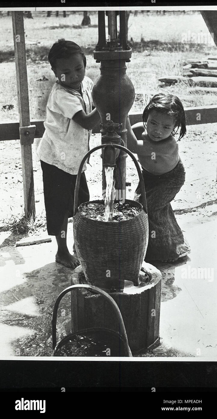 TWO KIDS AT THE WELL GETTING SOME WATER Stock Photo - Alamy