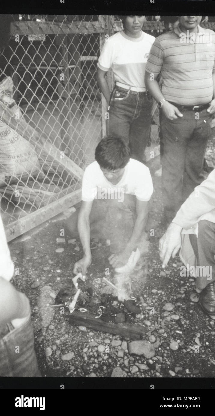 MAN STARTING A FIRE WITH OTHER PEOPLE WATCHING Stock Photo - Alamy