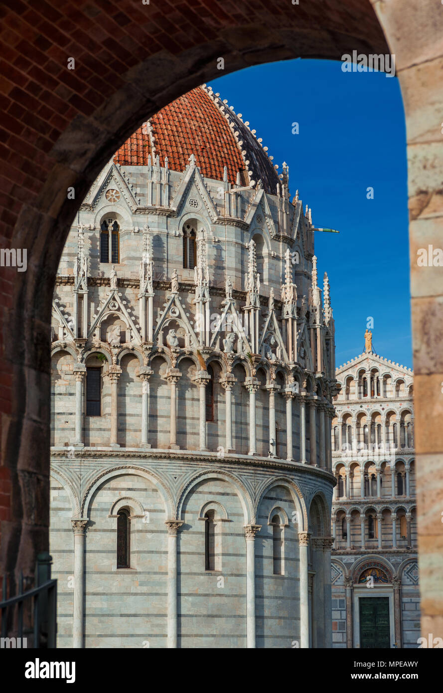 Pisa medieval Cathedral and Baptistry seen from city ancient walls gate ...