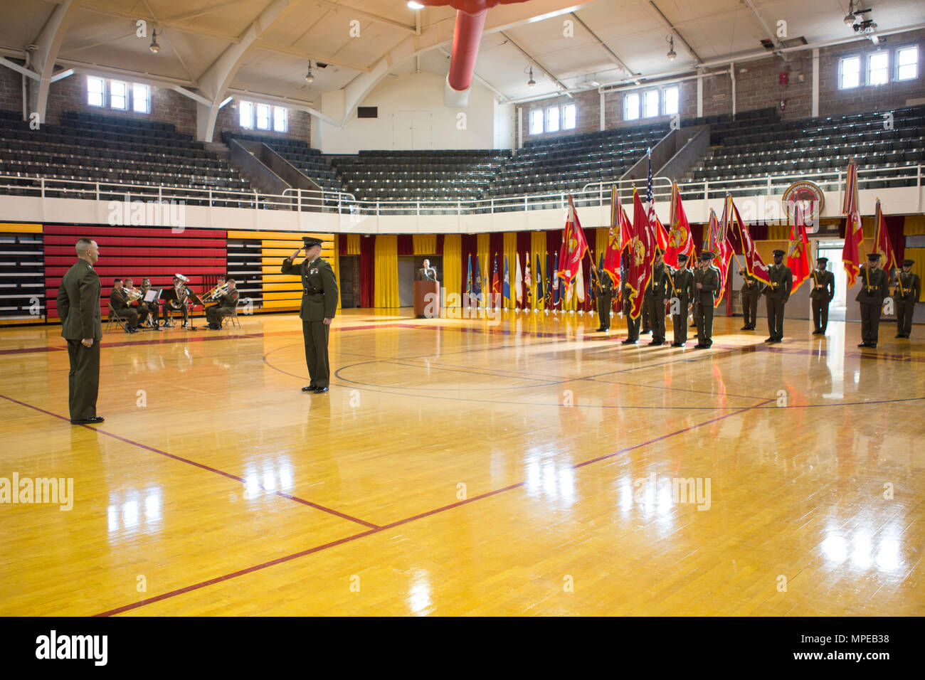 A U.S. Marine with 2nd Marine Division (2d MARDIV), center, salutes Maj ...