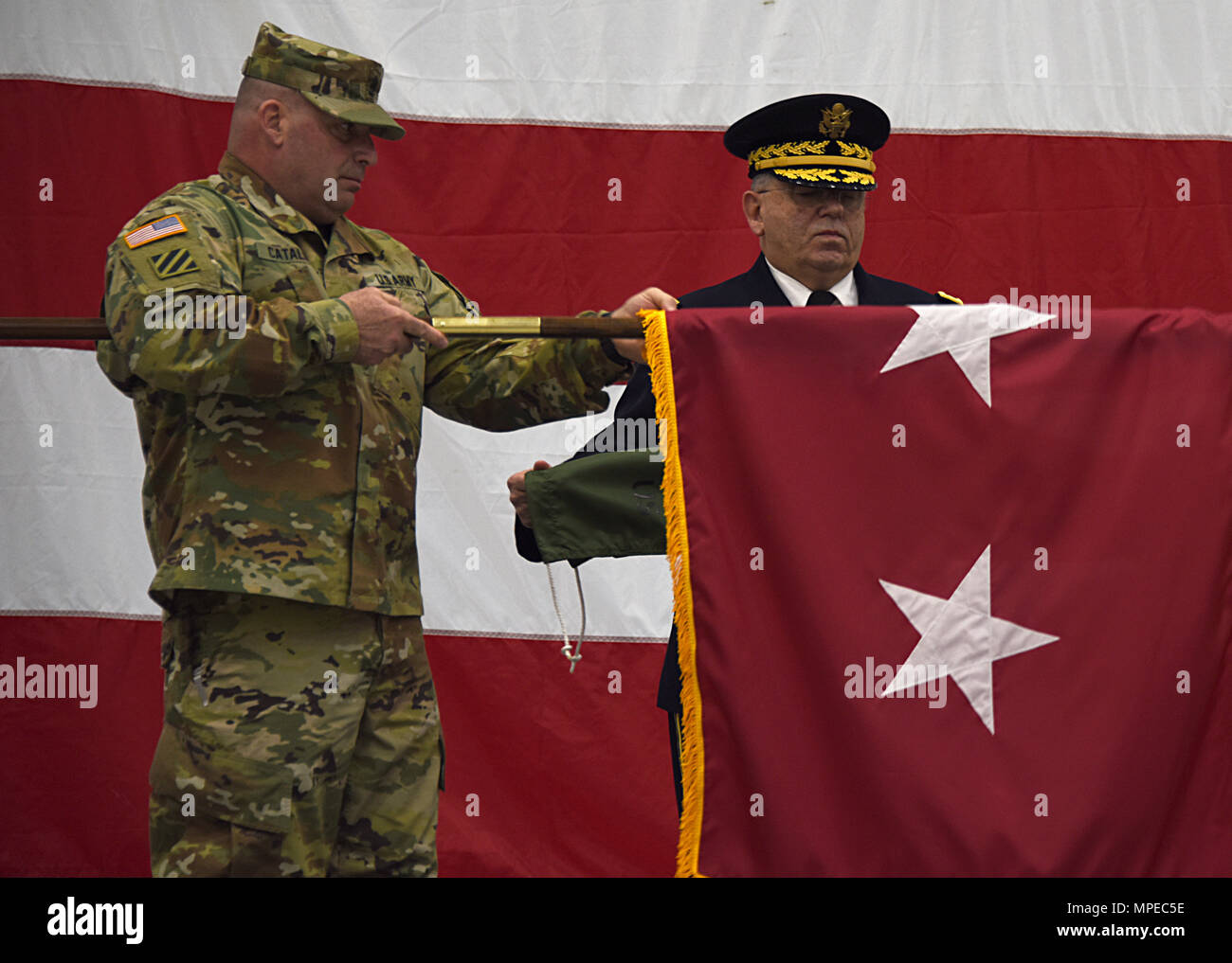 From left, Command Sgt. Maj. Donald J. Catalon furls the two star Army ...