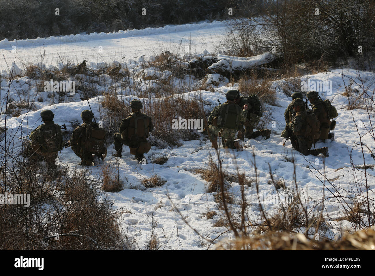 A Georgian soldier, center, of the 23rd Infantry Battalion discusses ...