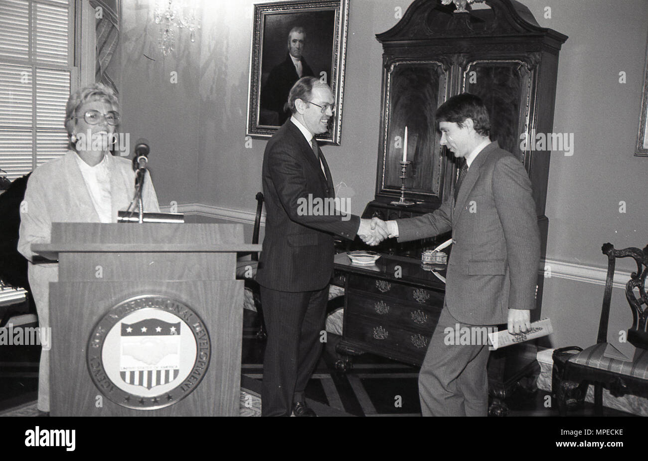 MAN GREETING ANOTHER MAN WITH A WOMEN AT THE PODIUM Stock Photo - Alamy