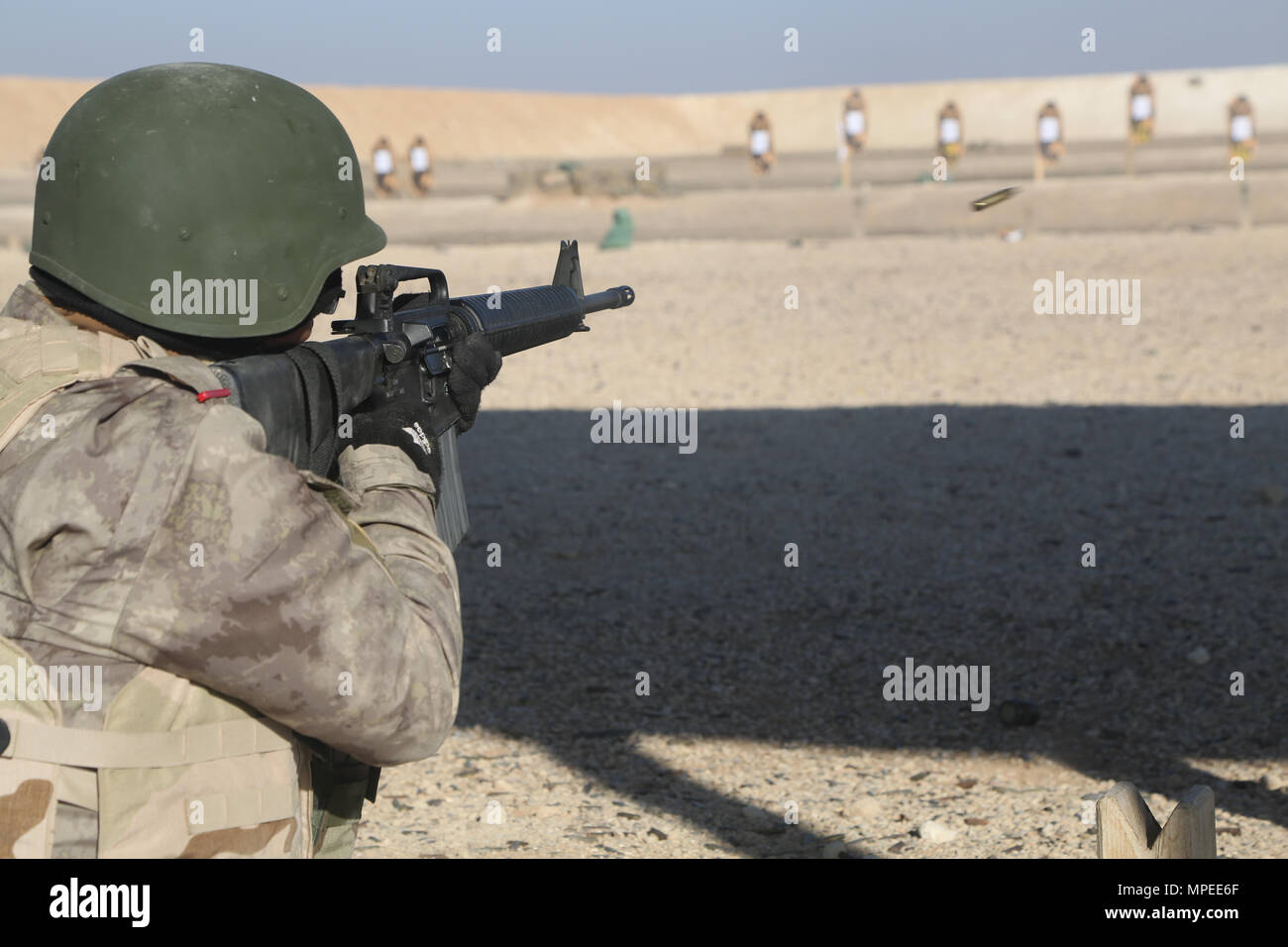 An Iraqi security forces soldier fires his M16 rifle during weapons ...