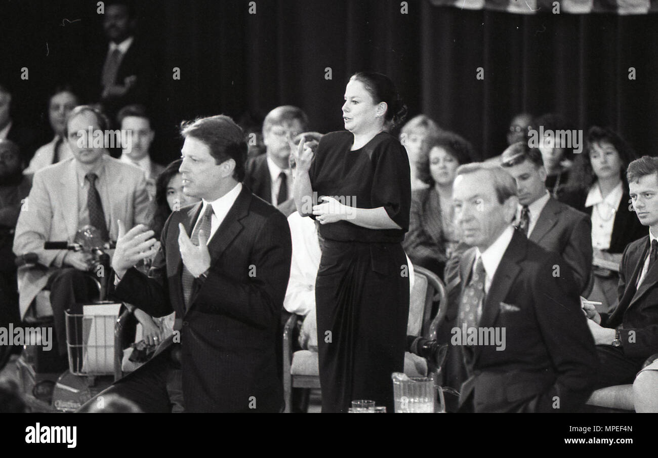 MAN TALKING TO CROWD AND WOMAN DOING SIGN LANGUAGE BEHIND HIM Stock ...
