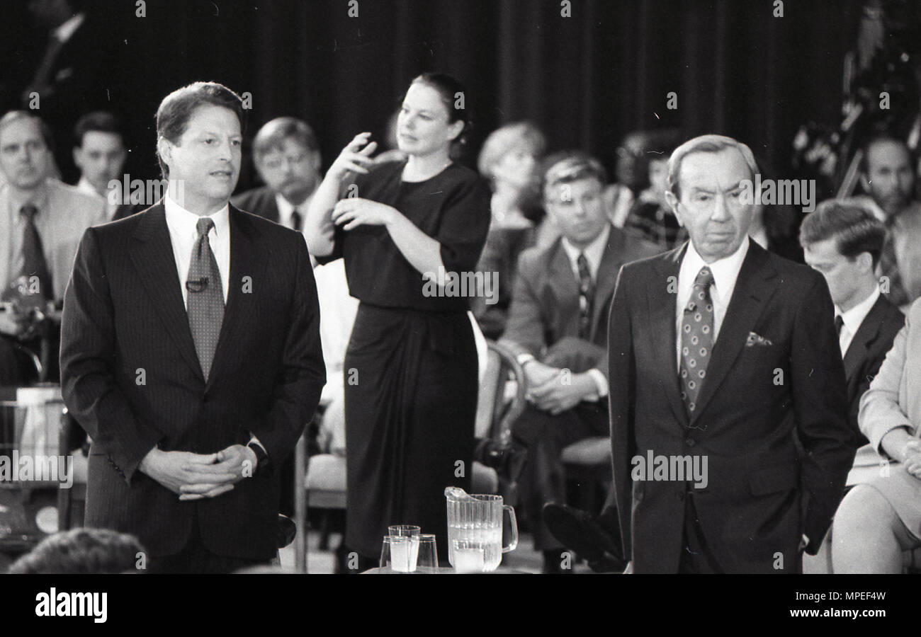 MAN TALKING TO CROWD AND WOMAN DOING SIGN LANGUAGE BEHIND HIM Stock ...