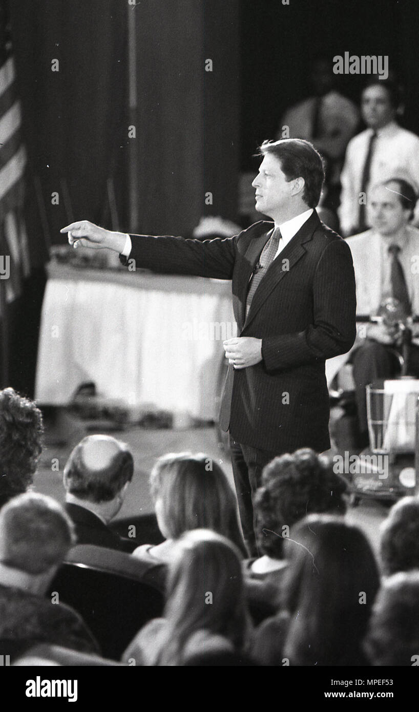 MAN TALKING TO CROWD AND WOMAN DOING SIGN LANGUAGE BEHIND HIM Stock ...