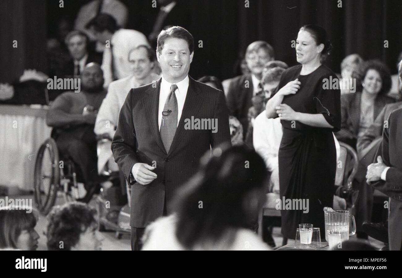 MAN TALKING TO CROWD AND WOMAN DOING SIGN LANGUAGE BEHIND HIM Stock ...