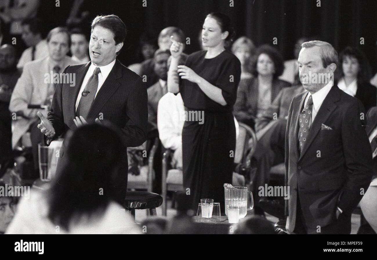 MAN TALKING TO CROWD AND WOMAN DOING SIGN LANGUAGE BEHIND HIM Stock ...