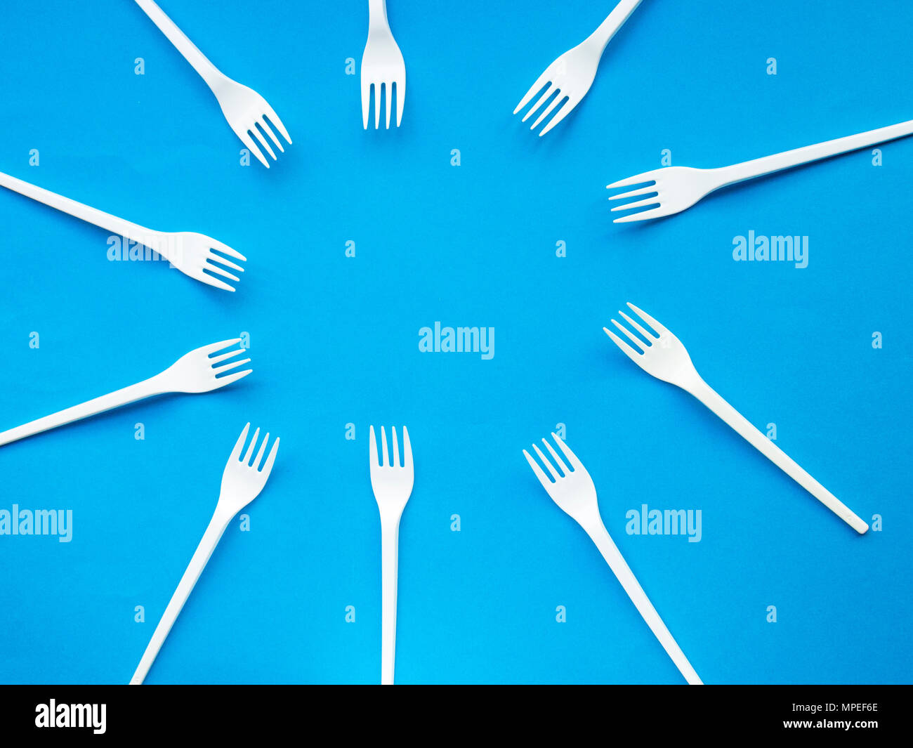 Plastic fork pattern on blue background Stock Photo - Alamy