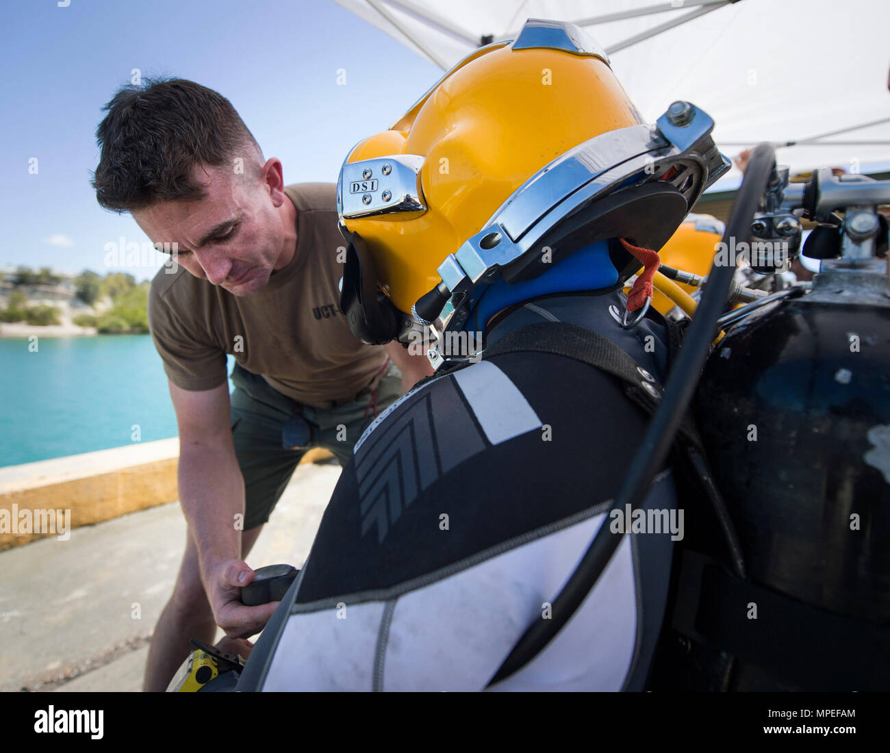 Builder 1st Class Garrett Snyder, left, assigned to Underwater ...