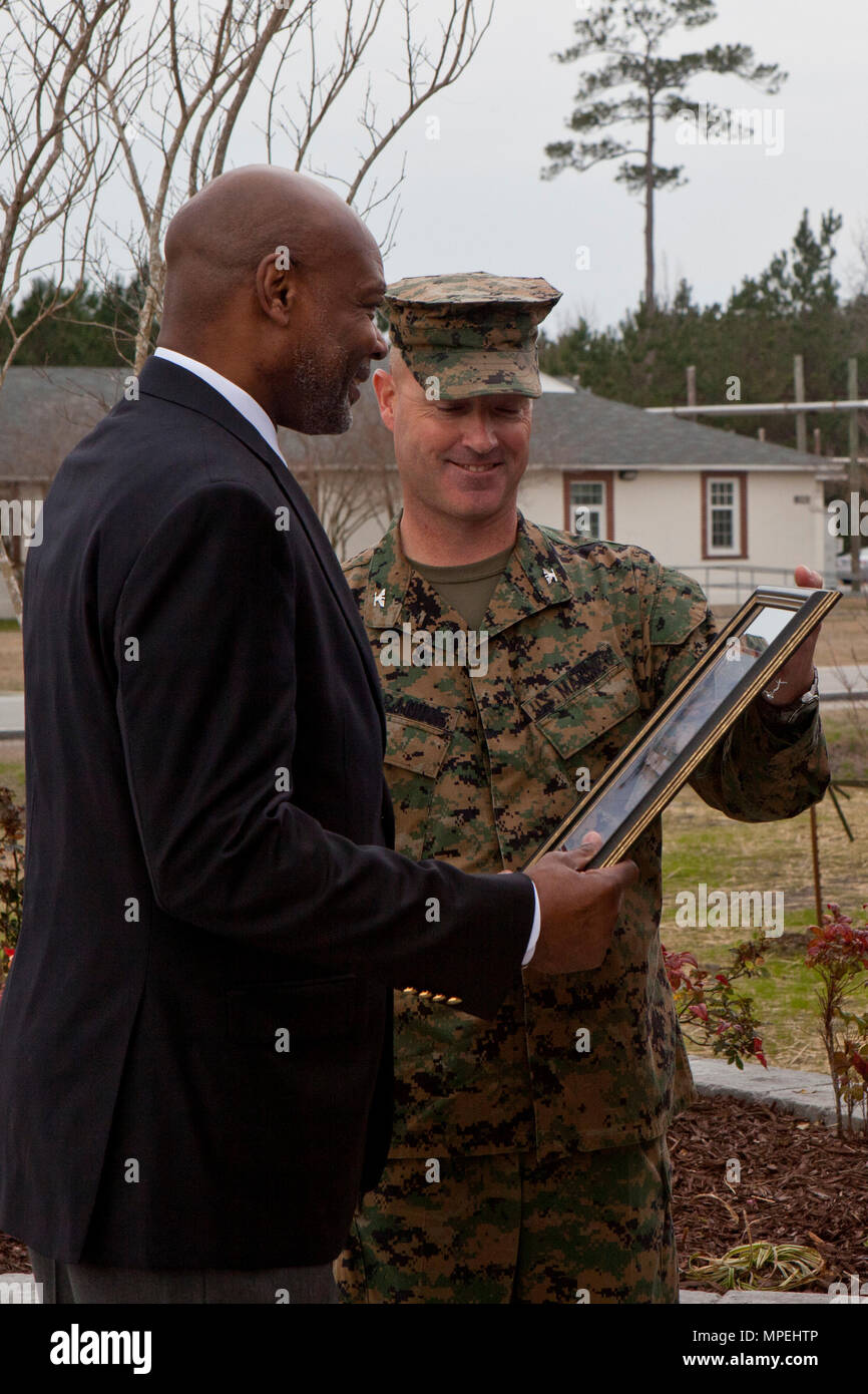 Retired U.S. Marine Corps Col. Grover C. Lewis, left, receives a gift ...