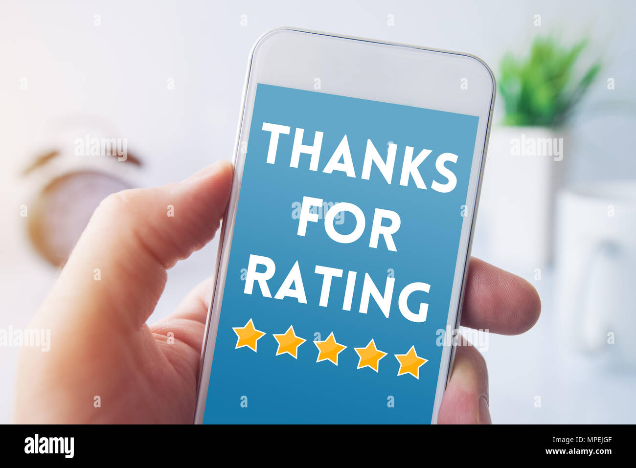 Thanks for rating message on smartphone screen in male hand. Customer ...