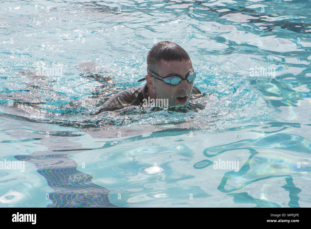 A Marine with Headquarters and Headquarters Squadron participates in a ...