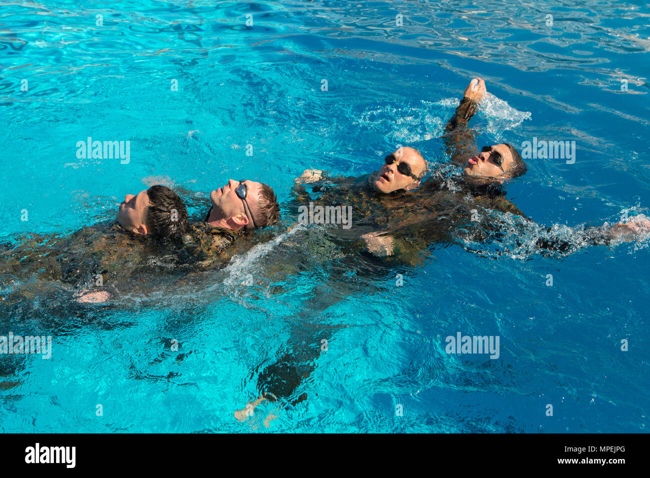 Marines with Headquarters and Headquarters Squadron swim in a “dragon ...