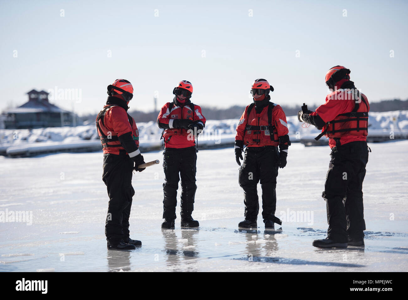 U.S. Coast Guard Rear Adm. Steven Poulin, center left, commander, First ...