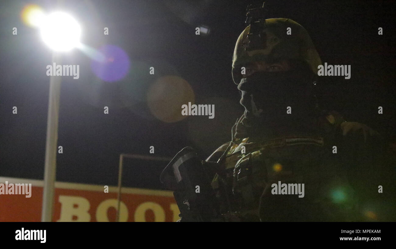 Iraqi federal police stand guard at the entrance of the Combined Joint ...