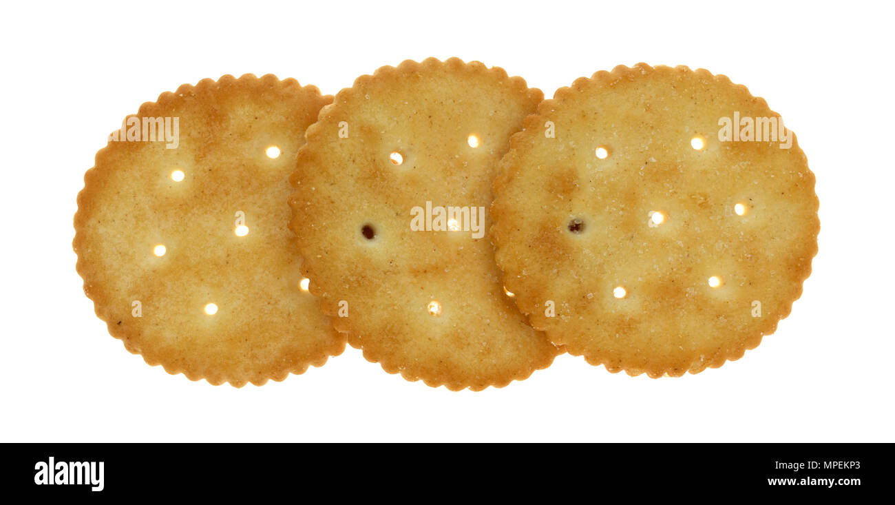 Top view of three yellow snack crackers with holes isolated on a white ...